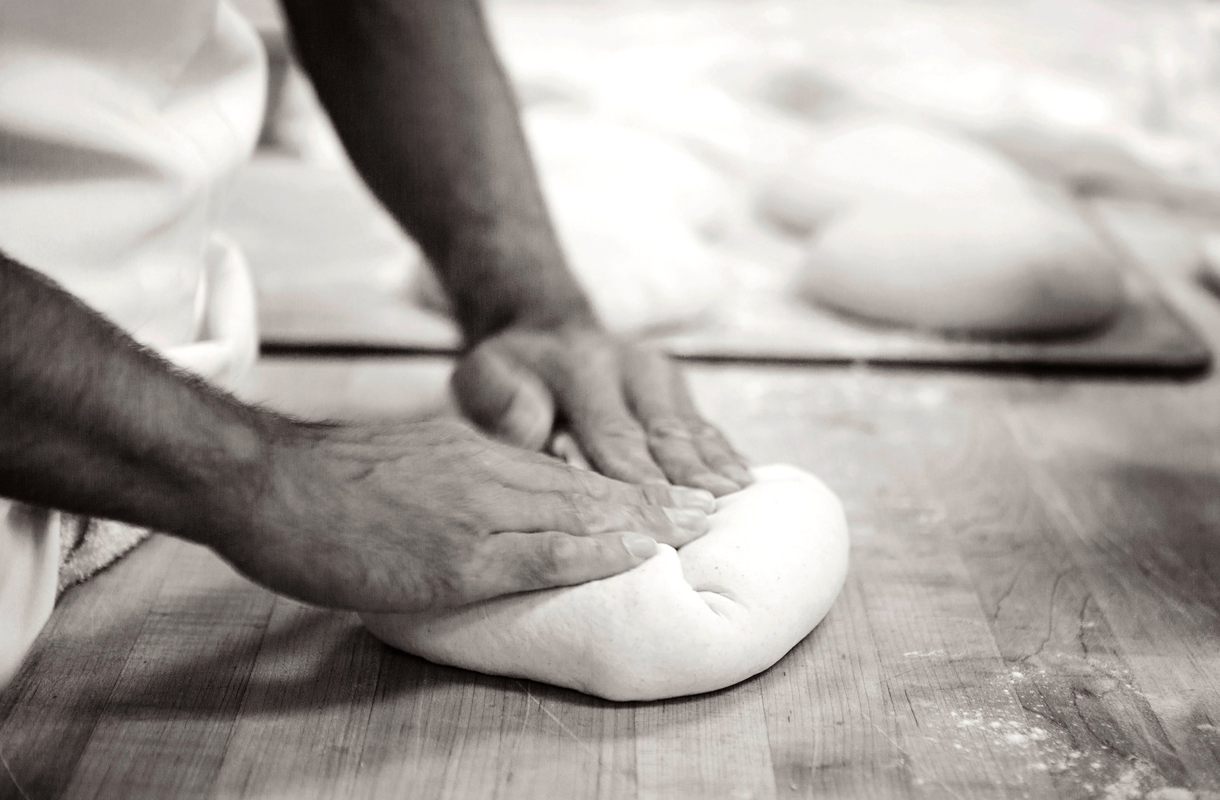 A baker's hands kneading artisan bread